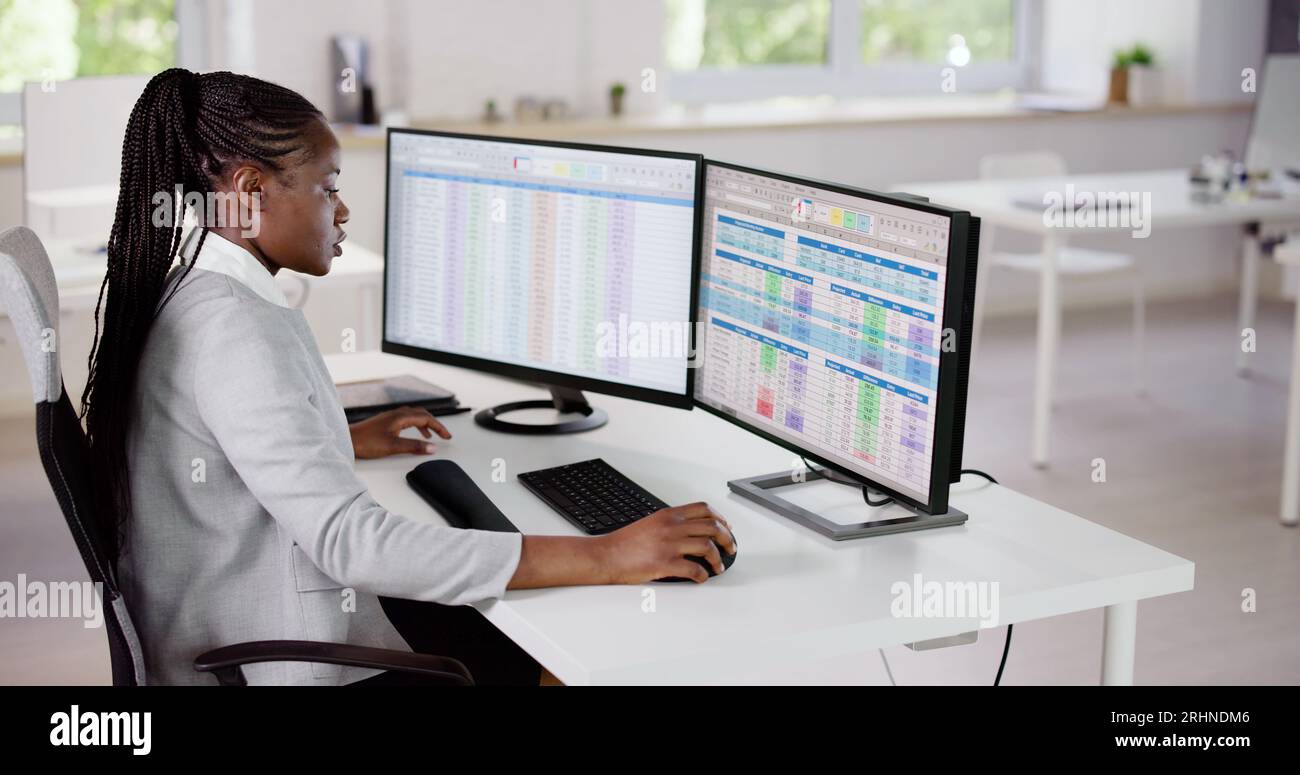 Data Analyst African Woman Using Spreadsheet On Computer Stock Photo ...