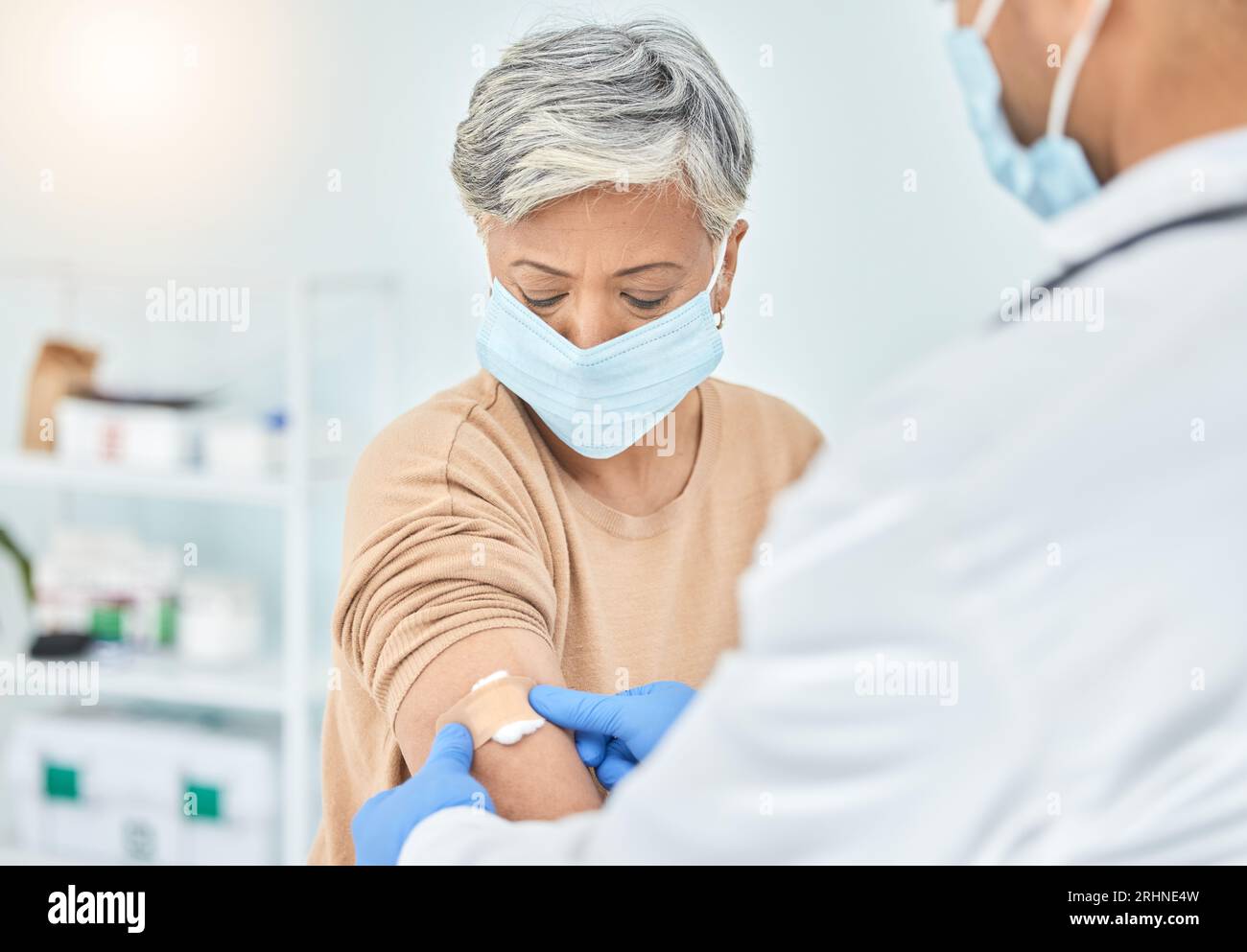 Doctor, senior patient and plaster, vaccine and wound treatment, safety ...