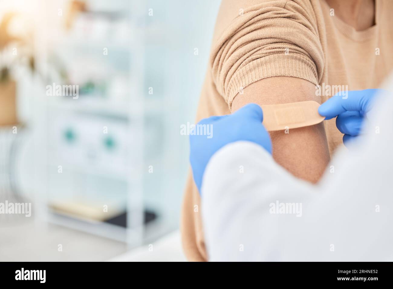 Bandaid, vaccine and arm of patient with doctor for healthcare, medical ...