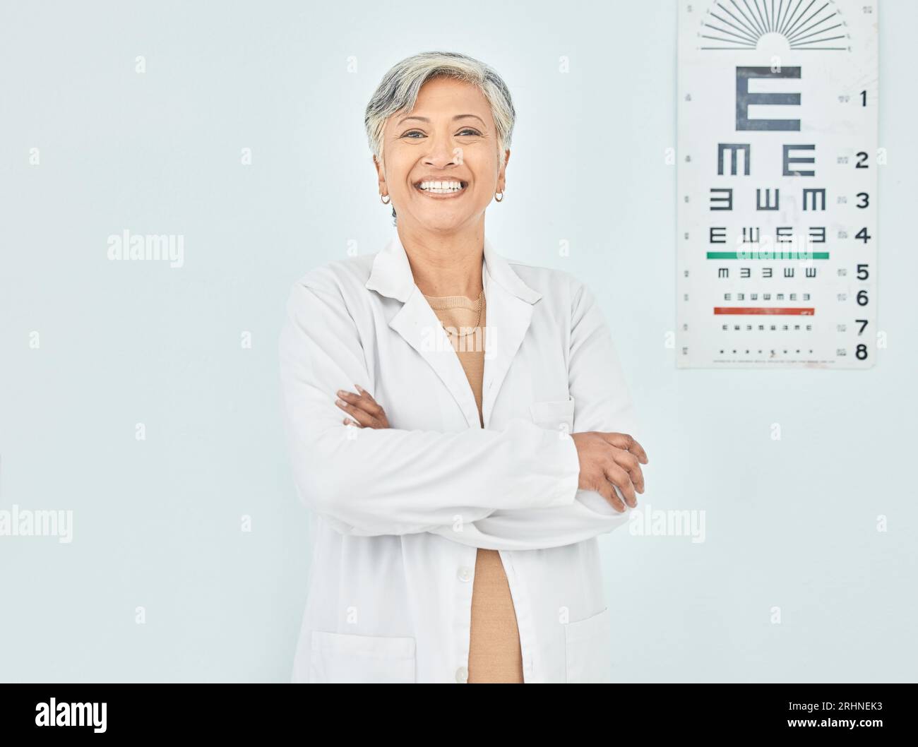Portrait, ophthalmologist and woman arms crossed in hospital mockup space for healthcare of ...