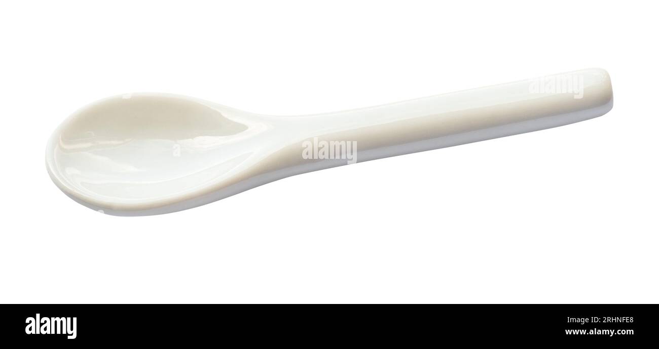 little white ceramic spoon cutout on white background Stock Photo - Alamy