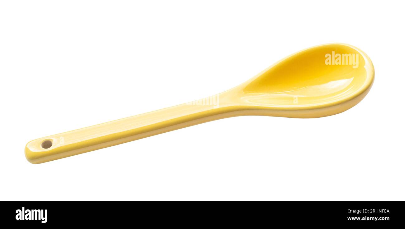 yellow ceramic tea spoon cutout on white background Stock Photo - Alamy