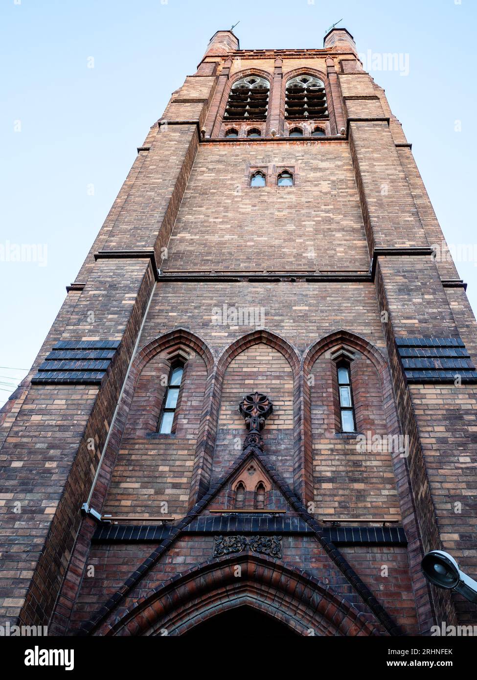 bottom view of tower of St Andrew's Anglican Church in summer twilight ...