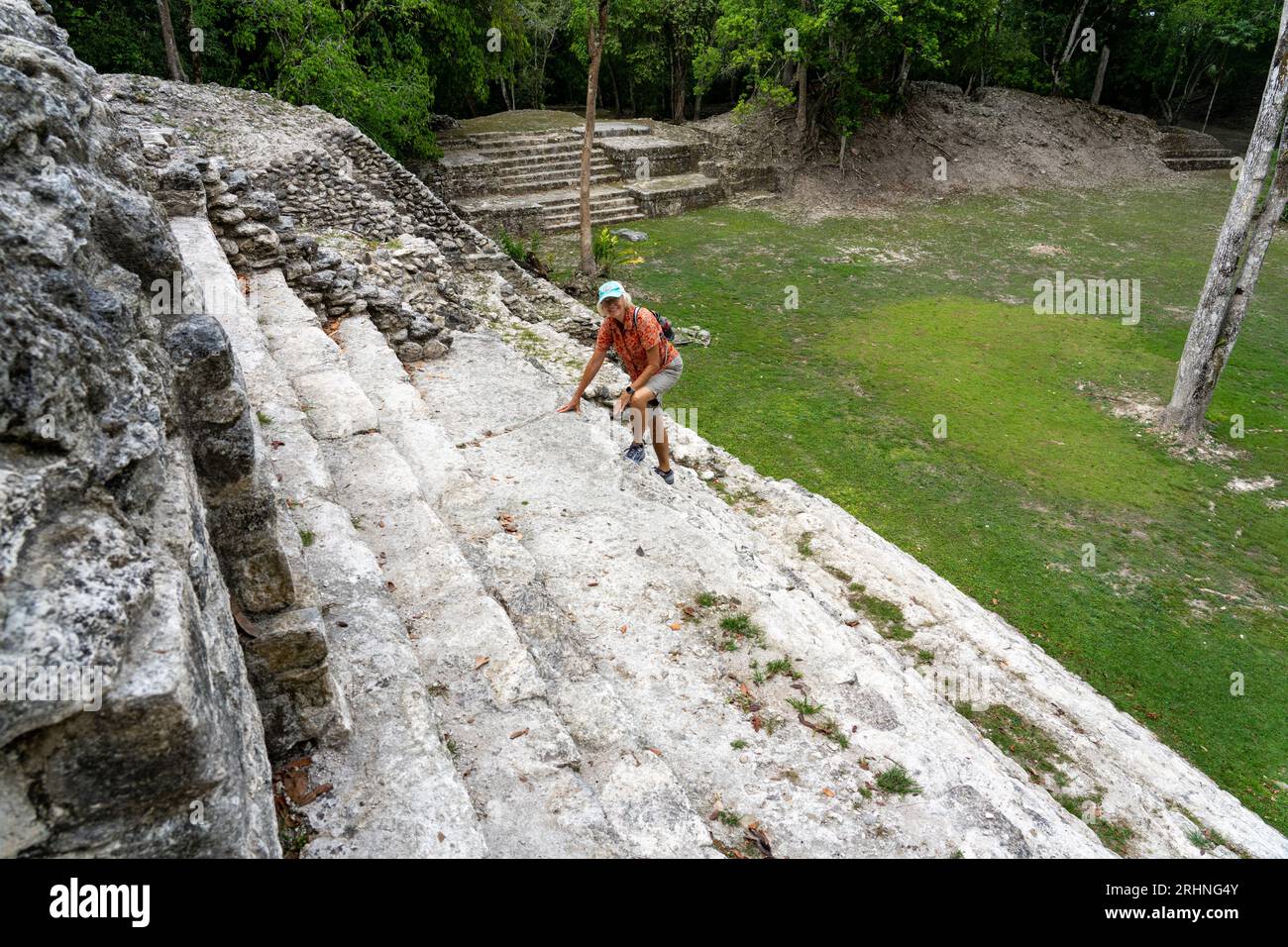 Tourist climbs the steep stairs of Pyramid or Structure B1 on Plaza B ...