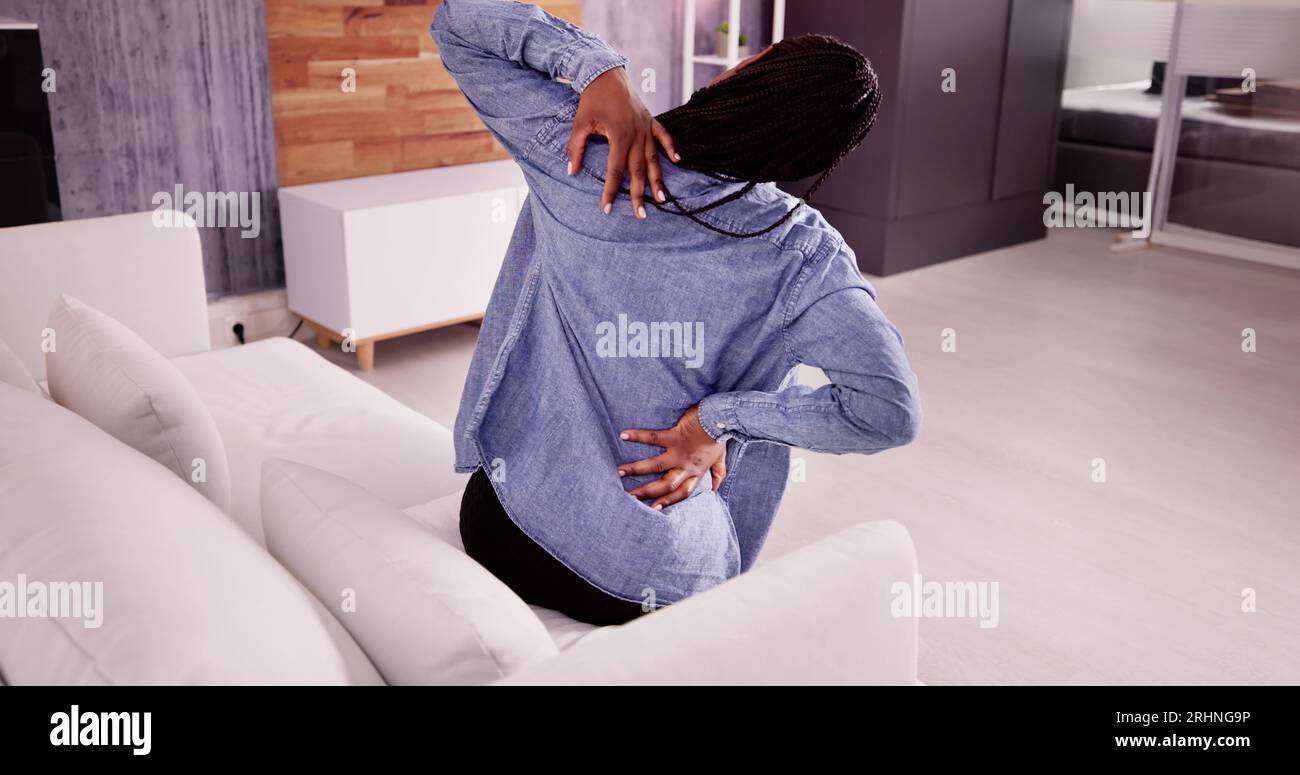 Woman Having Back Pain Or Backache In Living Room Stock Photo - Alamy