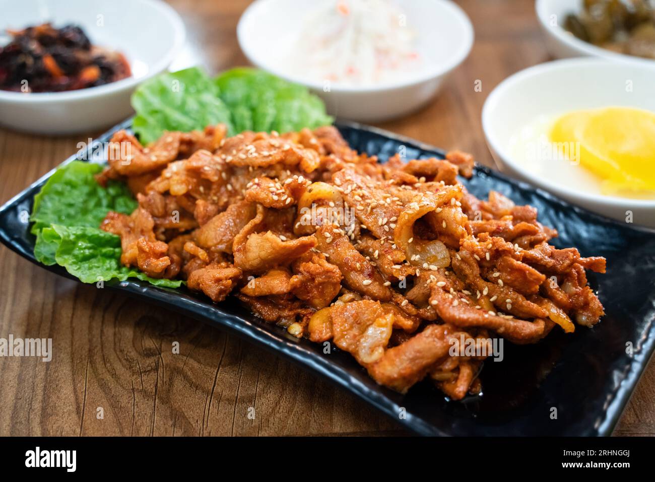 Delicious Korean cuisine jeyuk bokkeum, stir-fried pork in a plate for ...