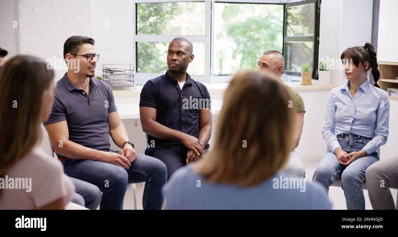 Young Multiracial Millennial Friends Sitting In Circle Having Group ...