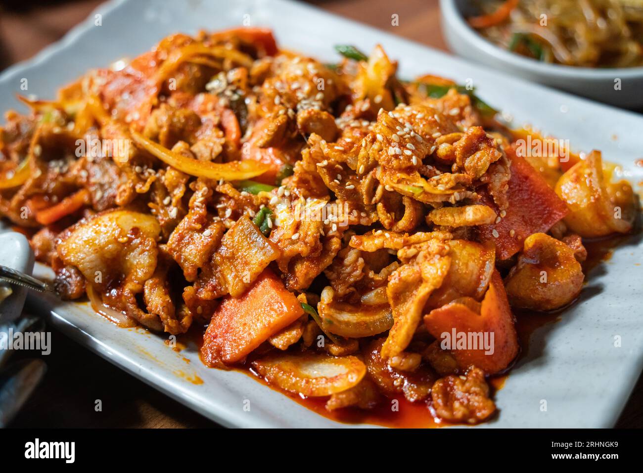 Delicious Korean cuisine jeyuk bokkeum, stir-fried pork in a plate for ...