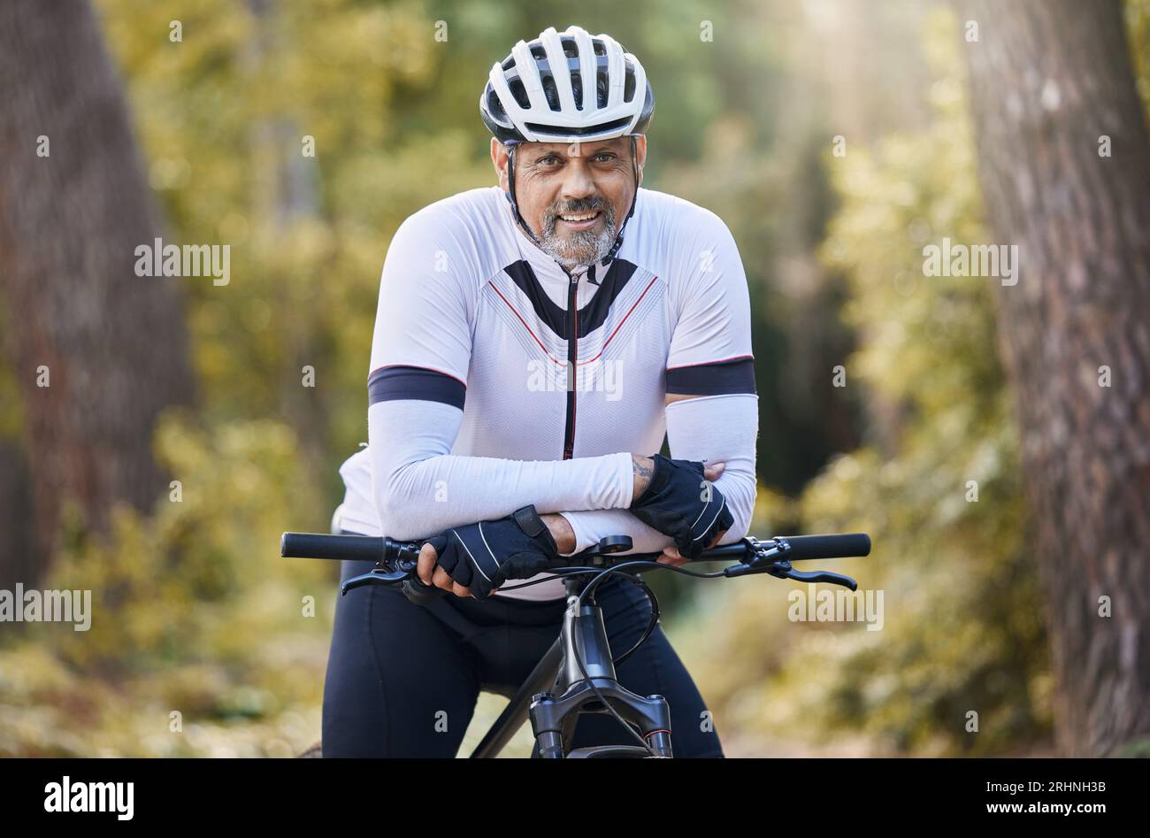 Fitness, portrait and senior man with bicycle in a forest for cycling ...