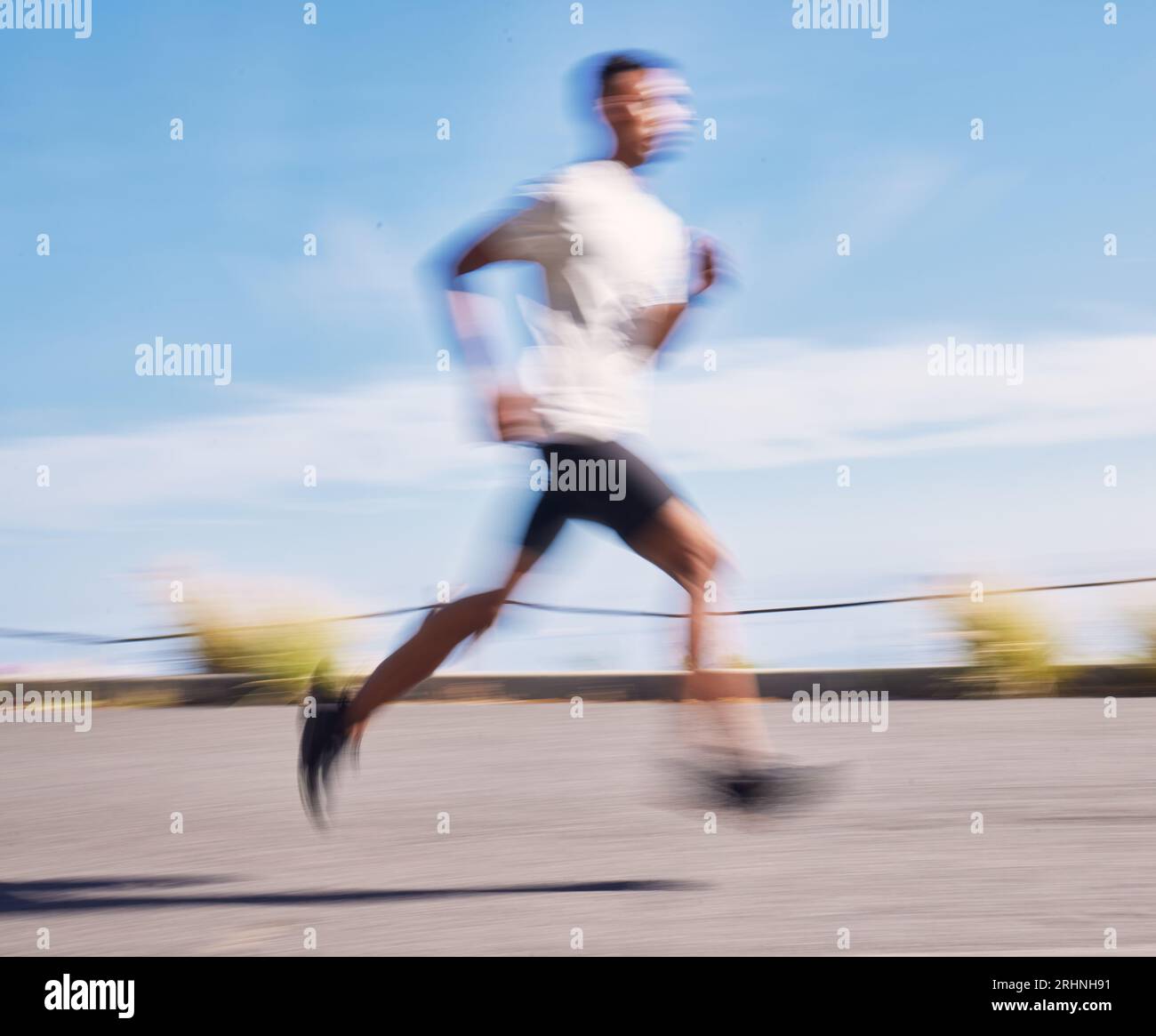 Exercise, running and motion blur with a sports man on a road for his ...