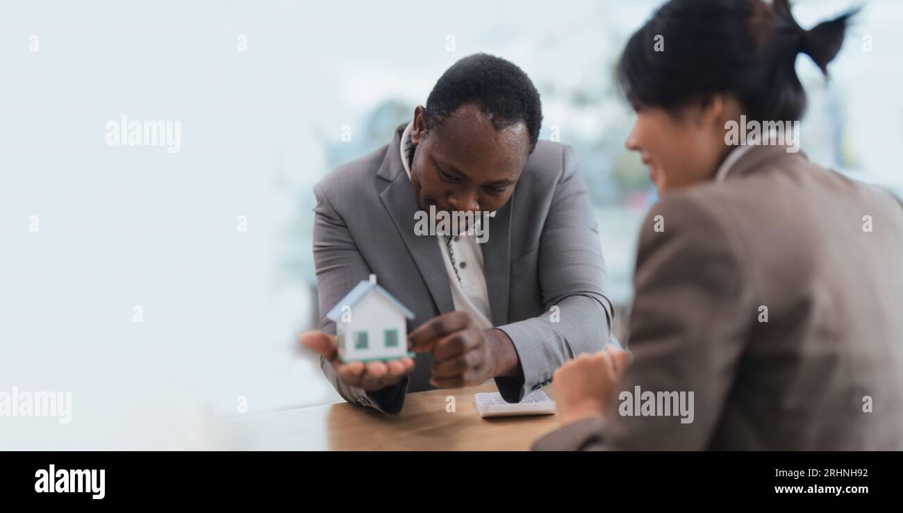 African american real estate agent showing house to his clients after ...