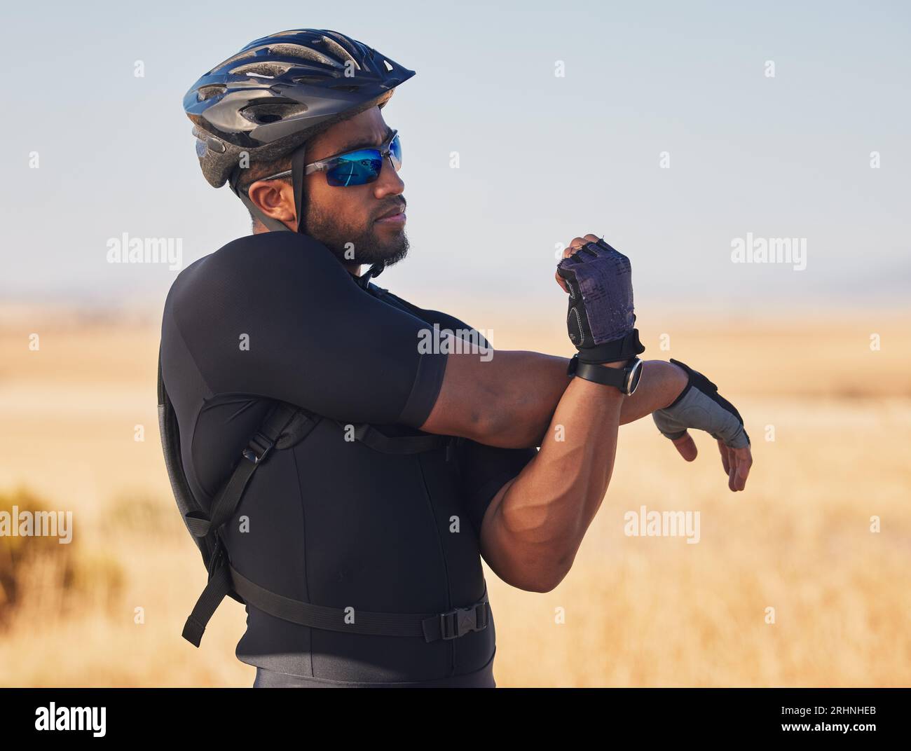 Fitness, nature and man cyclist stretching arms for race, marathon or ...