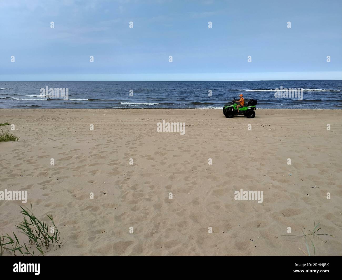 Beach on the Riga Daugavgriva seaside. Patrol ATV with a lifeguard ...