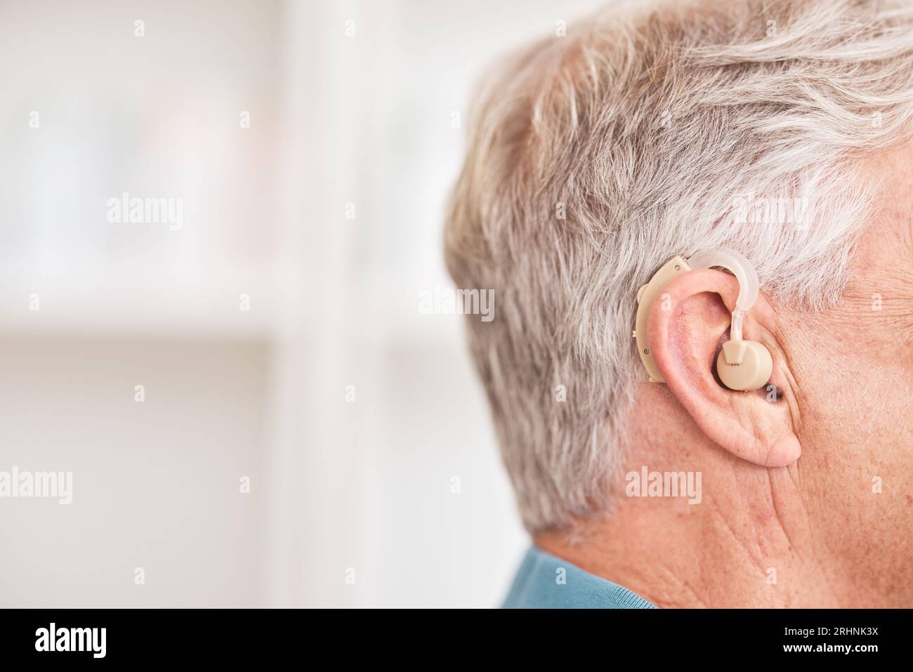 Hearing aid, closeup and ear of man with disability for medical support ...