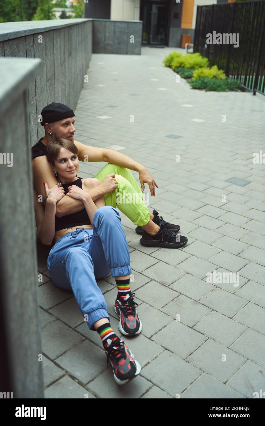 Young people sit hugging on the sidewalk Stock Photo - Alamy Young people sit hugging on the sidewalk Stock Photo - Alamy