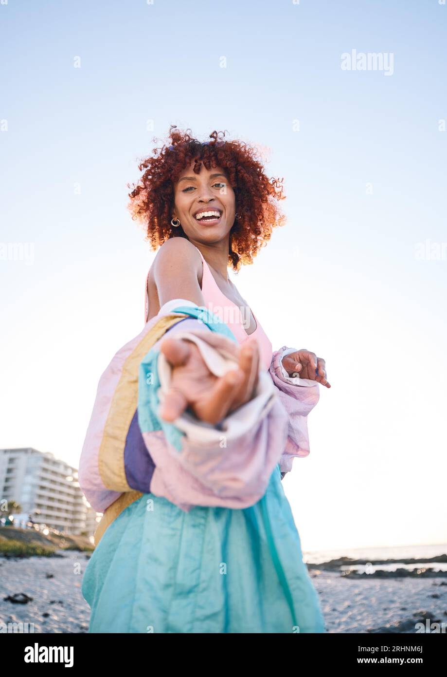 Portrait smile, woman and helping hand, offer or invitation at beach in ...