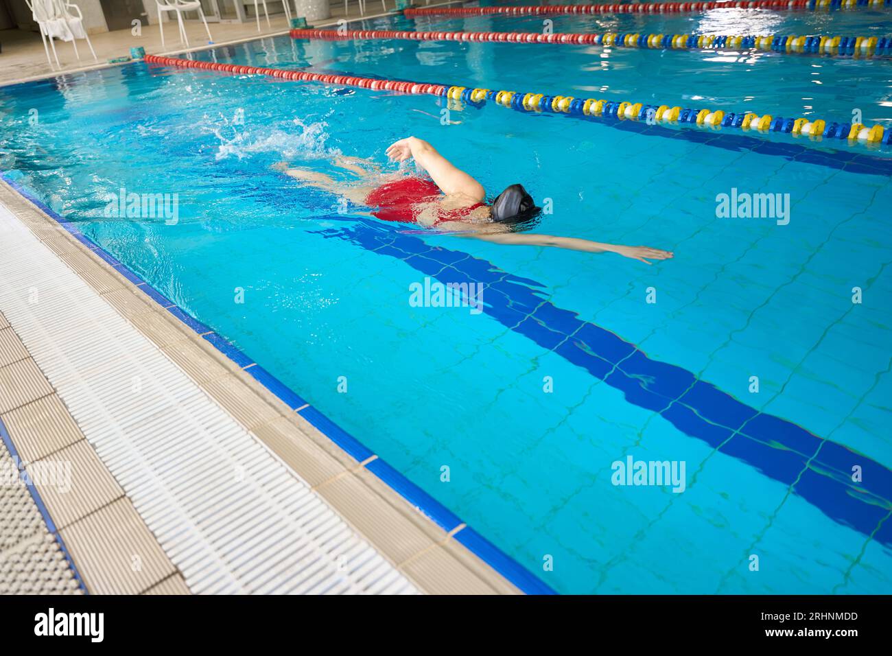 Athletic woman swimming front crawl in pool Stock Photo - Alamy