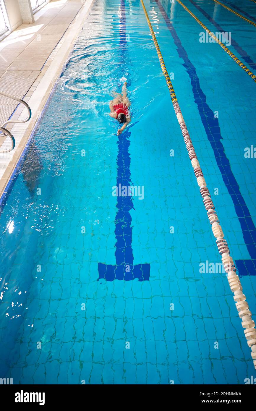 Female swimmer swimming on her back in pool Stock Photo - Alamy