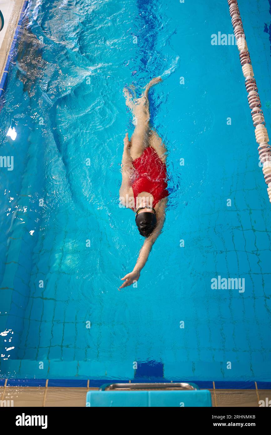 Caucasian sportswoman swimming on back in water Stock Photo - Alamy