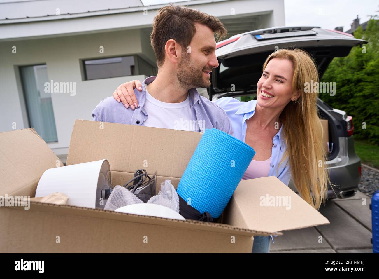 Wife hugs her husband in the yard of country cottage Stock Photo - Alamy