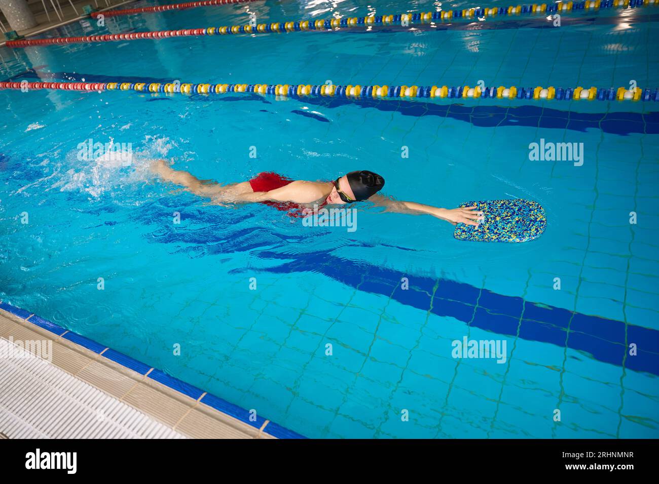 Young sportswoman practicing freestyle stroke in pool Stock Photo - Alamy