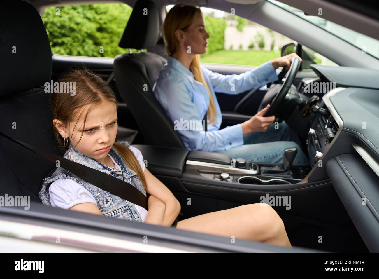 Upset girl is driving with her mother in a car Stock Photo - Alamy