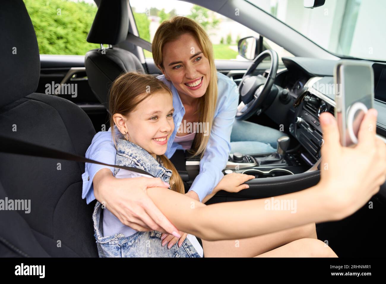 Beautiful mother with a teenage daughter sit hugging in car Stock Photo ...