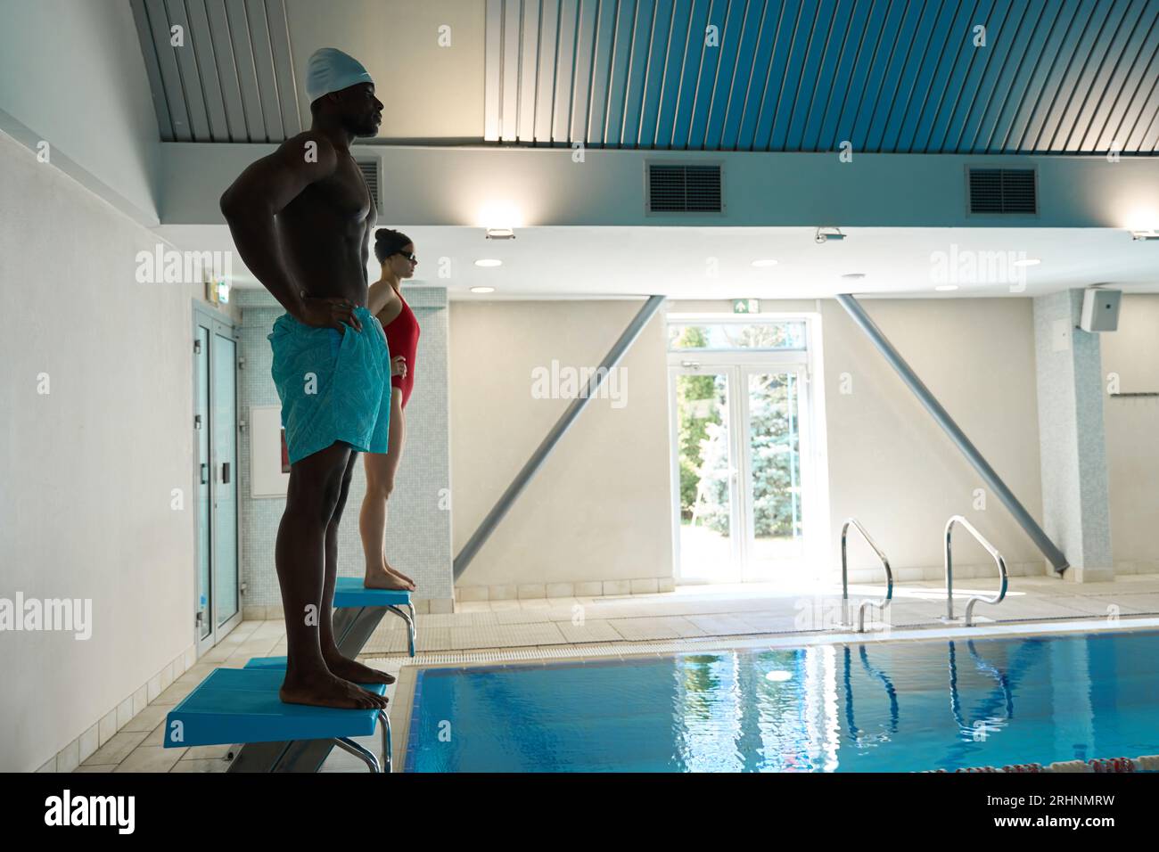 Professional athletes preparing to dive into pool water Stock Photo - Alamy