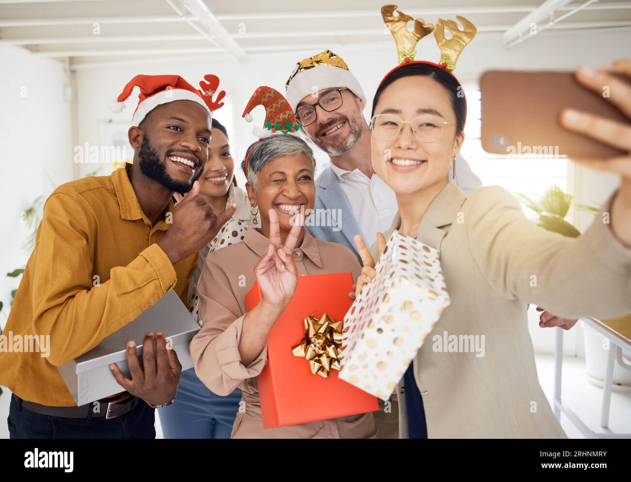 Business people, Christmas selfie and staff for smile, present or peace sign for celebration ...