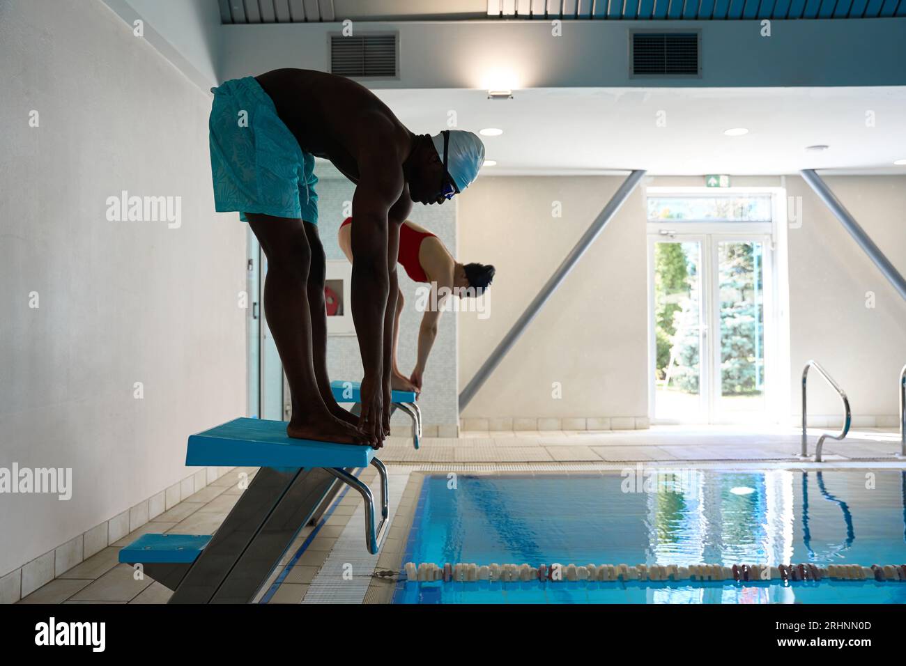 Sportsman and sportswoman getting ready to dive into water Stock Photo ...