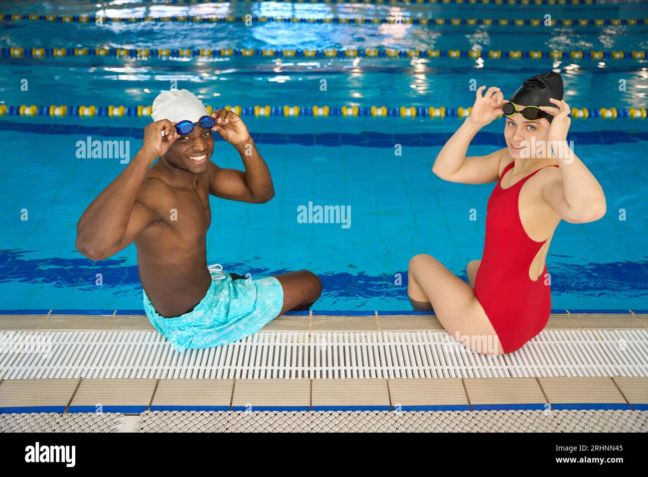Two athletes posing for camera at poolside Stock Photo - Alamy