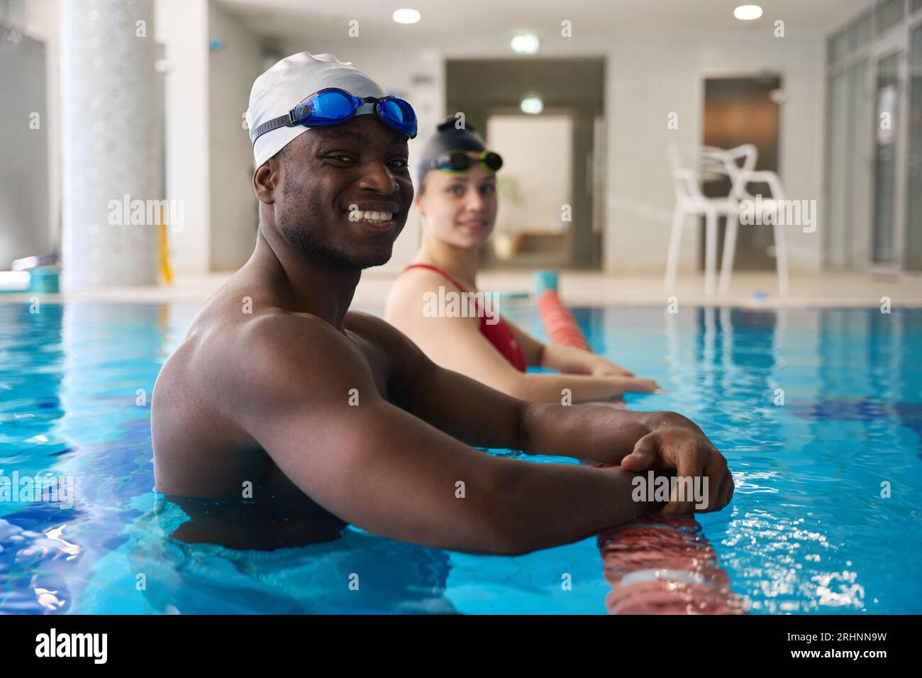 Young swimmers posing for camera in water Stock Photo - Alamy