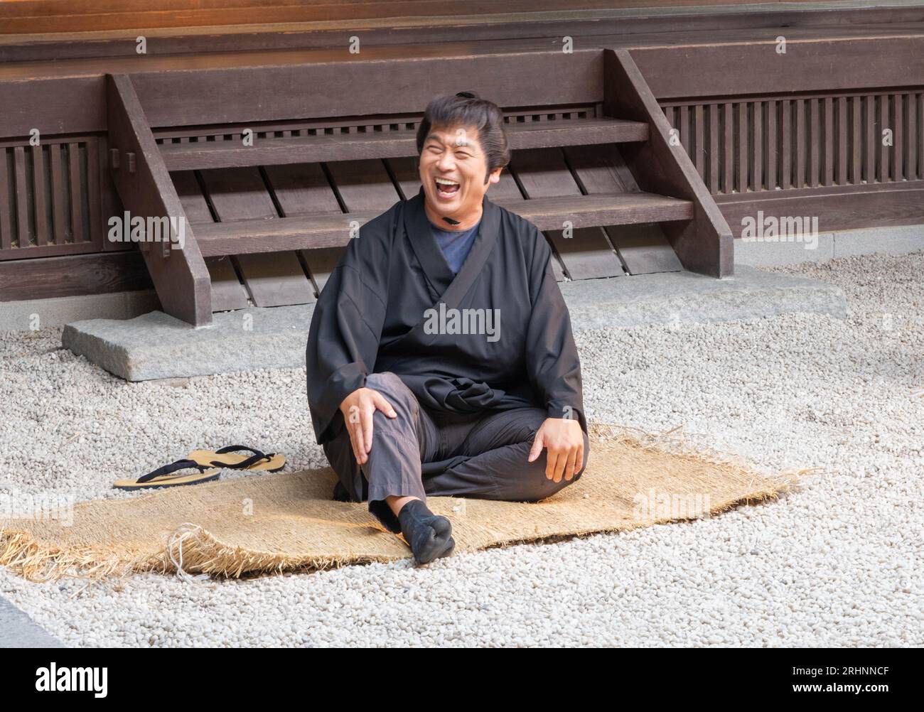 A men dressed in period costume playing the part of a criminal wearing ...