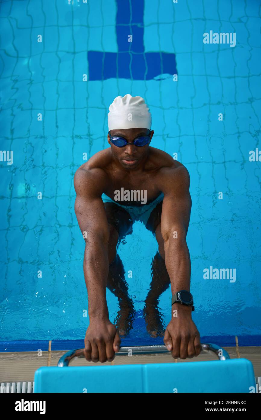 Young sportsman practicing his backstroke start technique Stock Photo ...