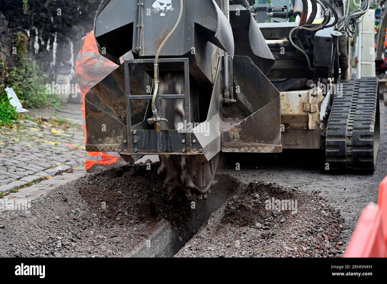 Trenching machine (Bobcat) being used for cutting channel through ...
