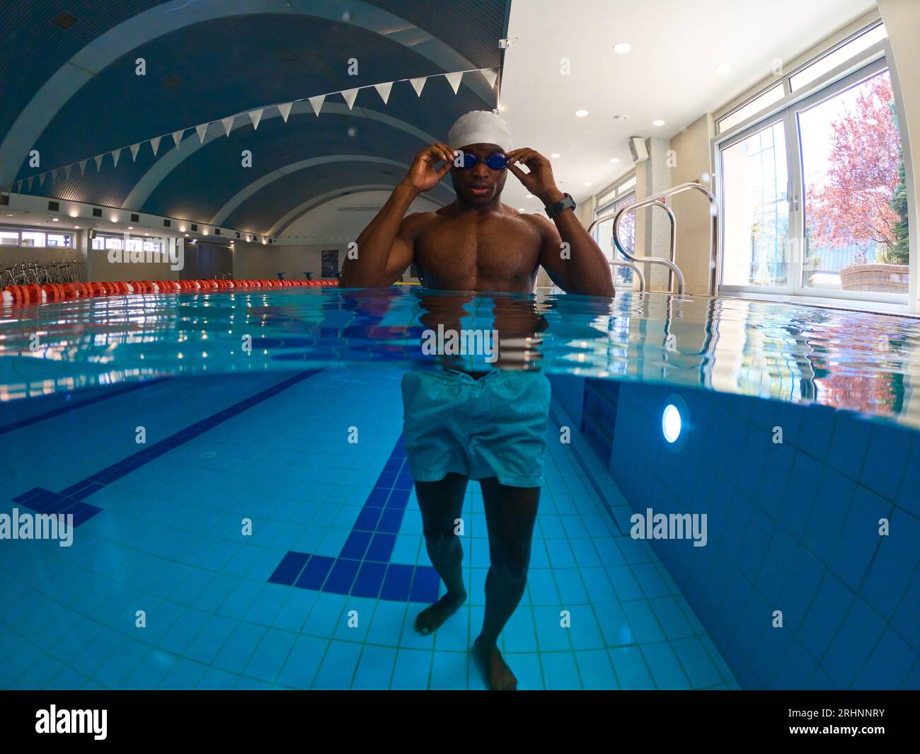 Confident swimmer getting ready to swim in sports pool Stock Photo - Alamy
