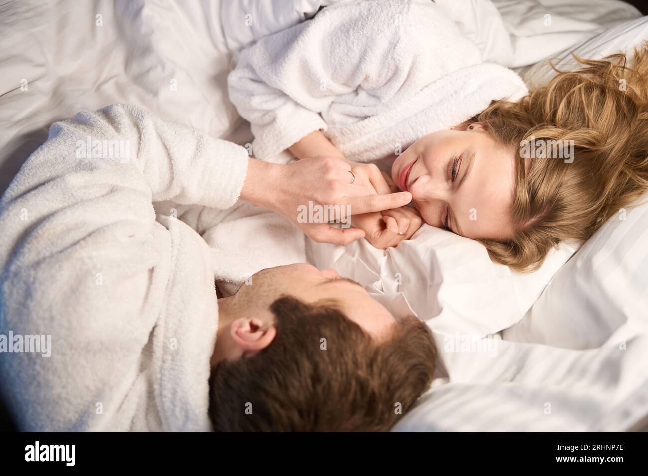 Husband tenderly touching nose of his beloved wife, caressing her face ...