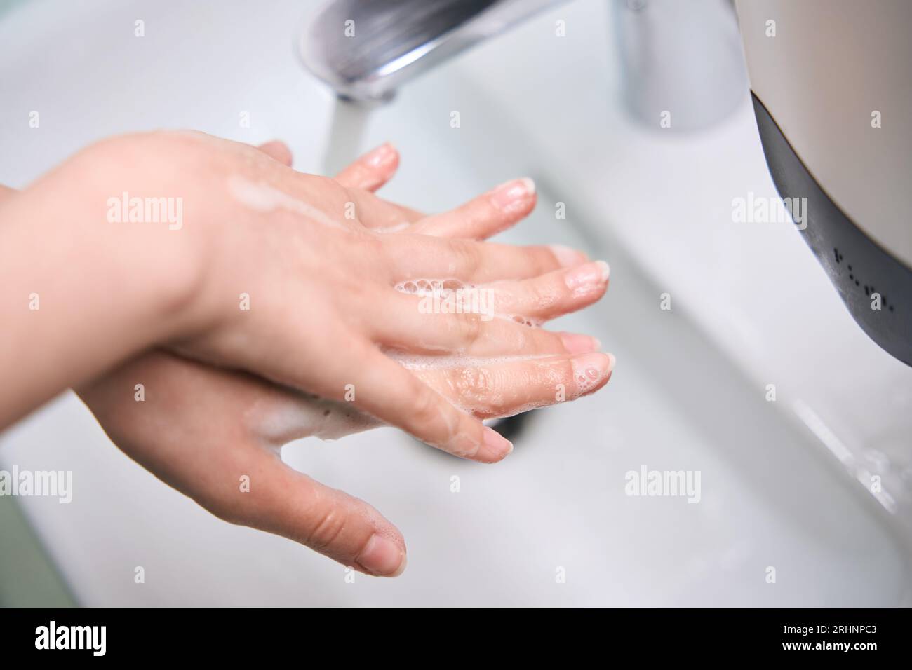Female washes her soapy hands under the tap Stock Photo - Alamy