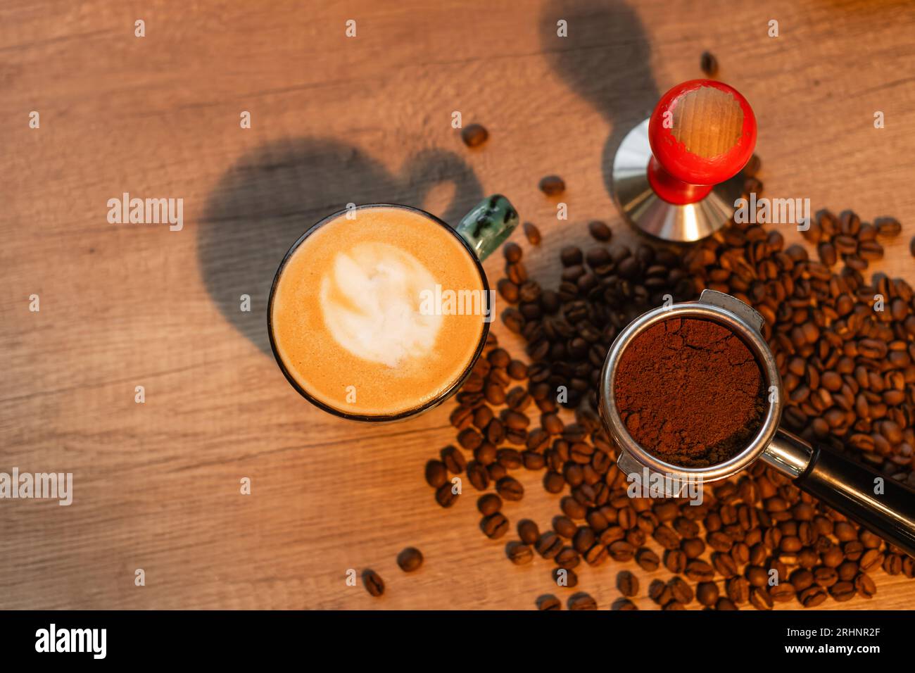 top view of cappuccino, press and coffee beans with lighting in coffee ...