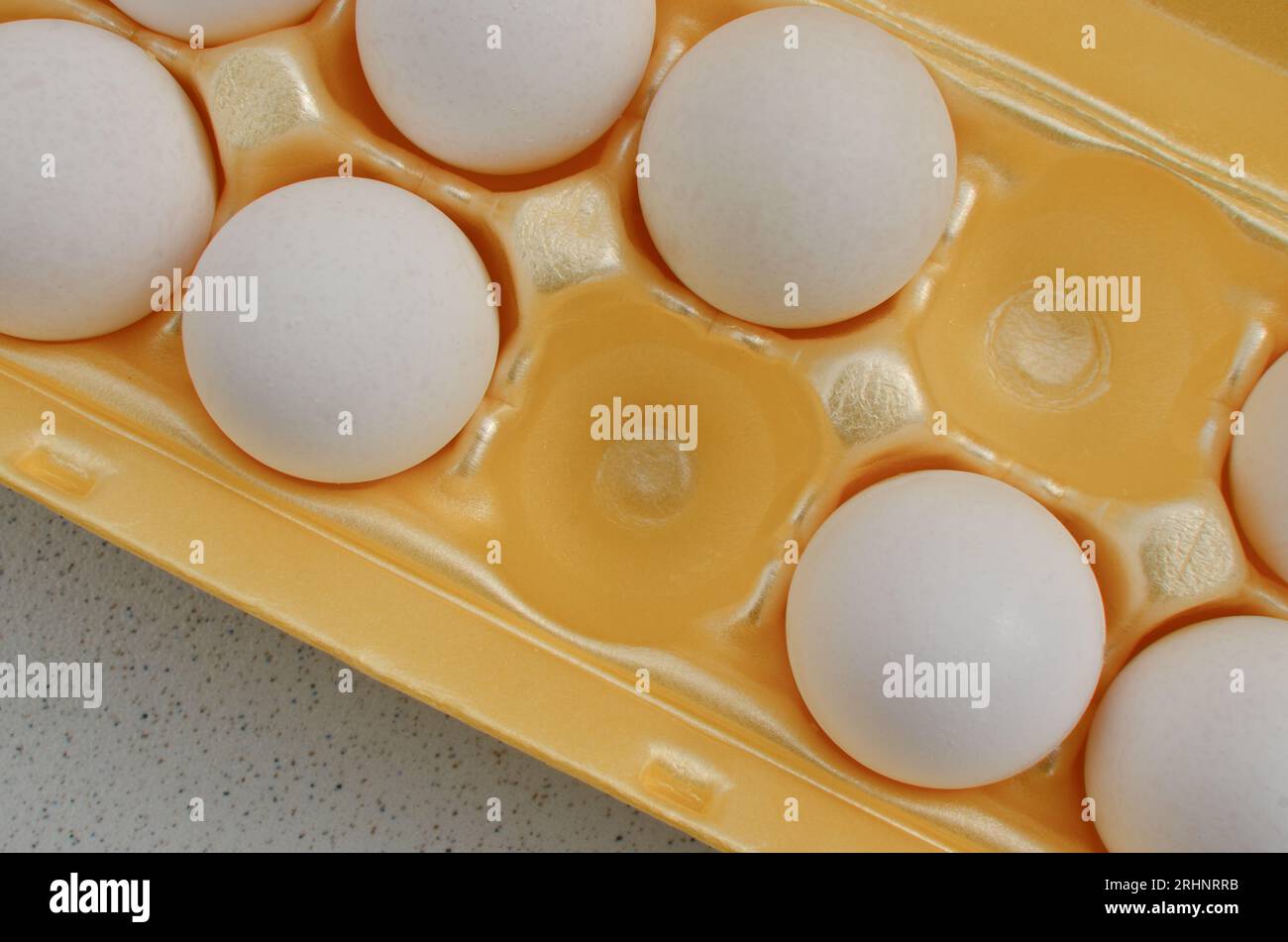 Stunning detail of yellow packaging with fresh white eggs, symbol of ...