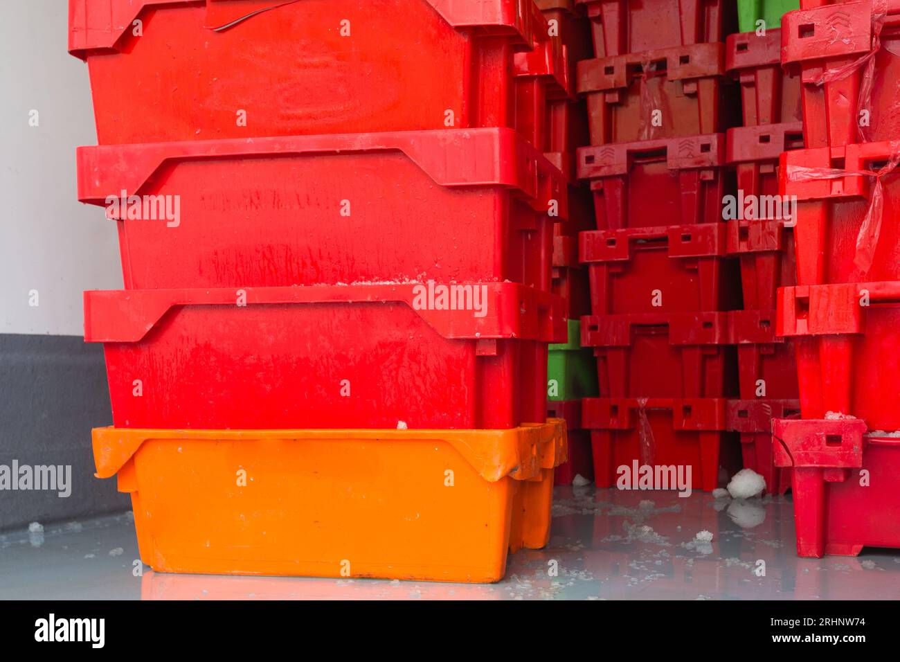 plastic crates or packing cases stacked with fresh fish in a ...