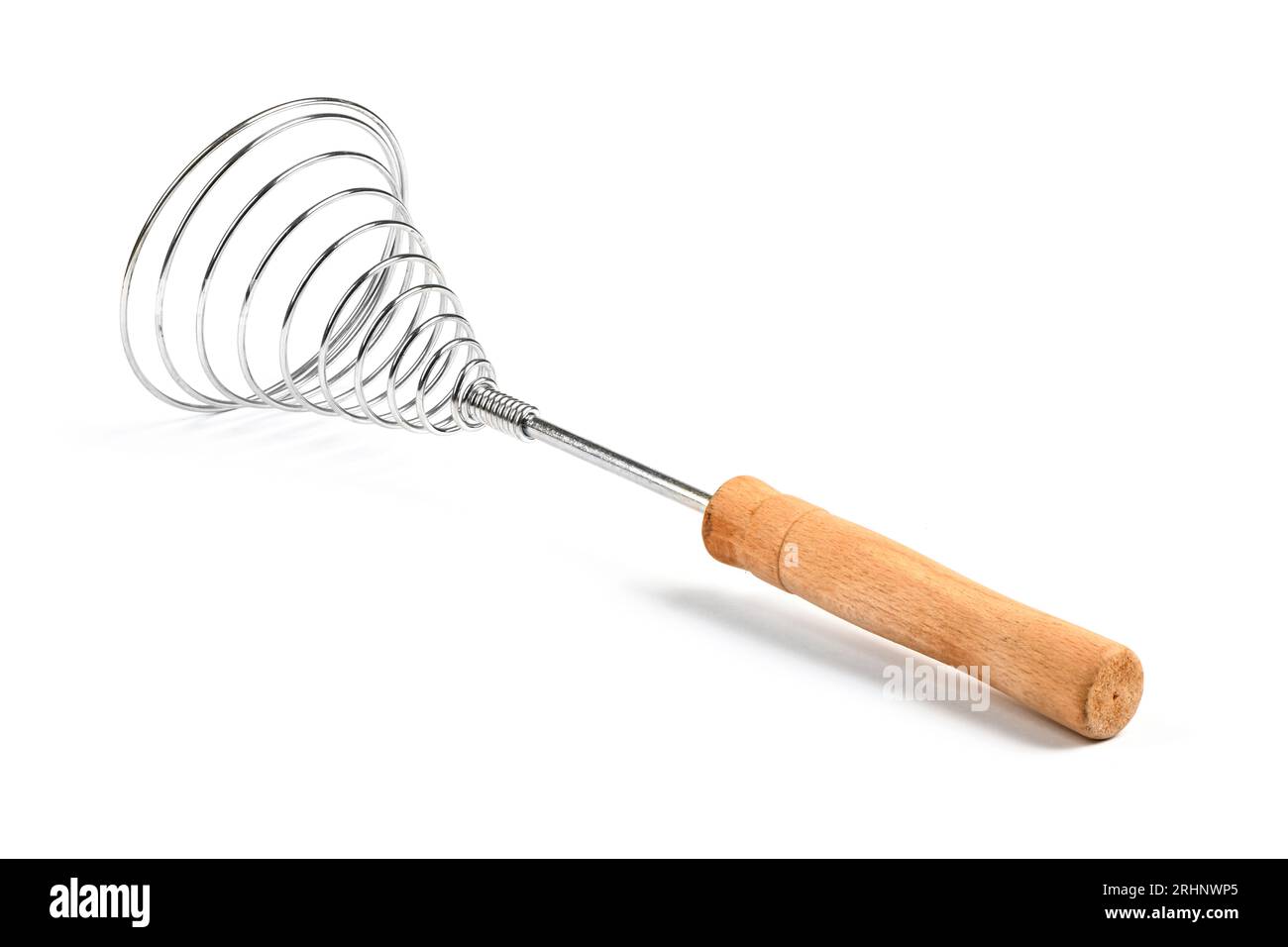 Close-up of old retro whisk kitchen tool on white background. Side view ...