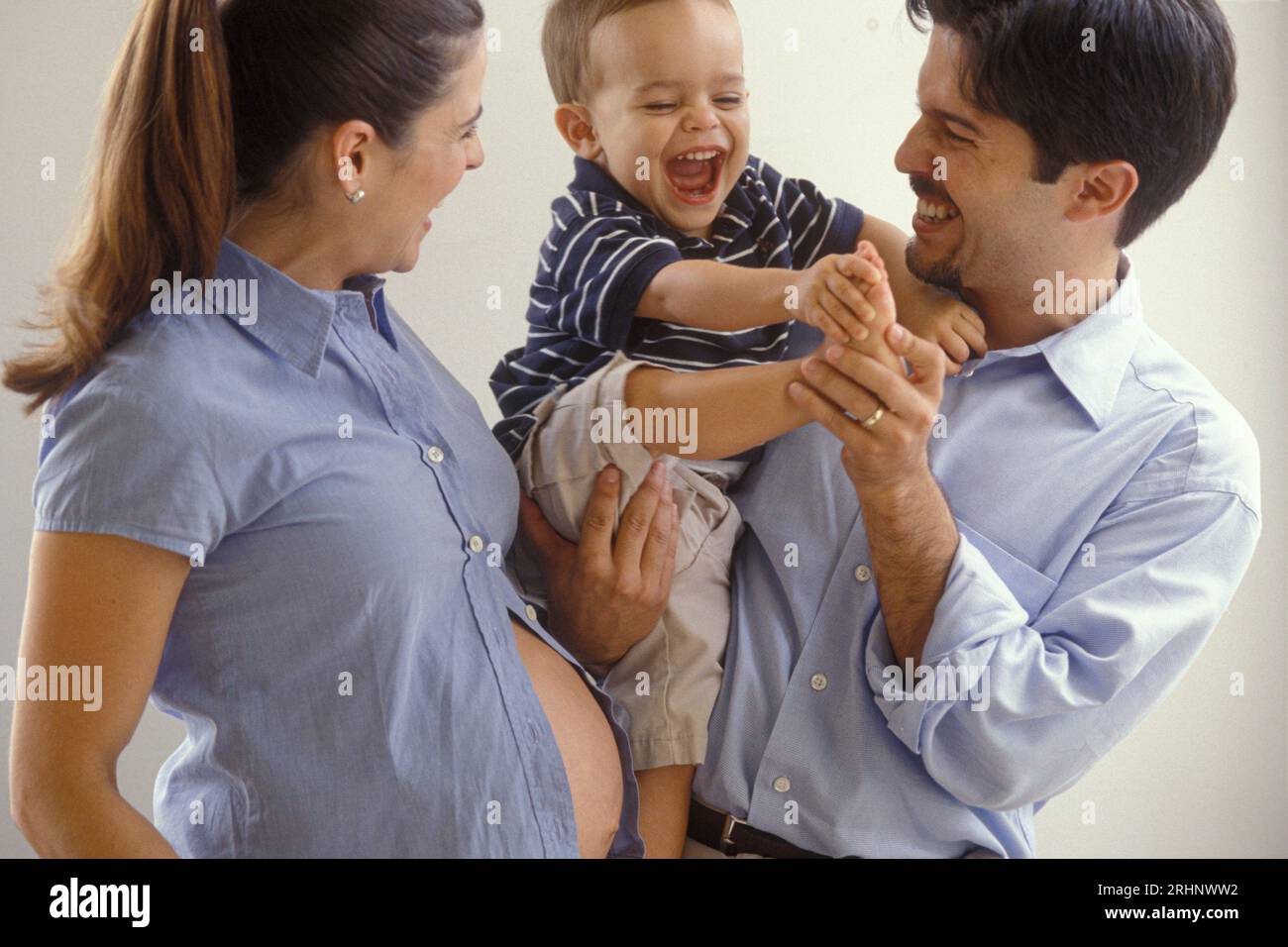 Portrait of happy expecting family with one son at home Stock Photo - Alamy