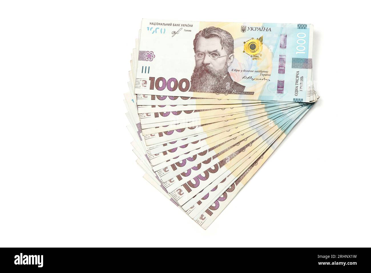 Thousand banknotes hryvnia lying in a heap isolated on white background ...