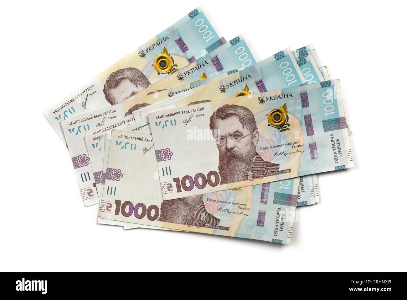 Thousand banknotes hryvnia lying in a heap isolated on white background ...