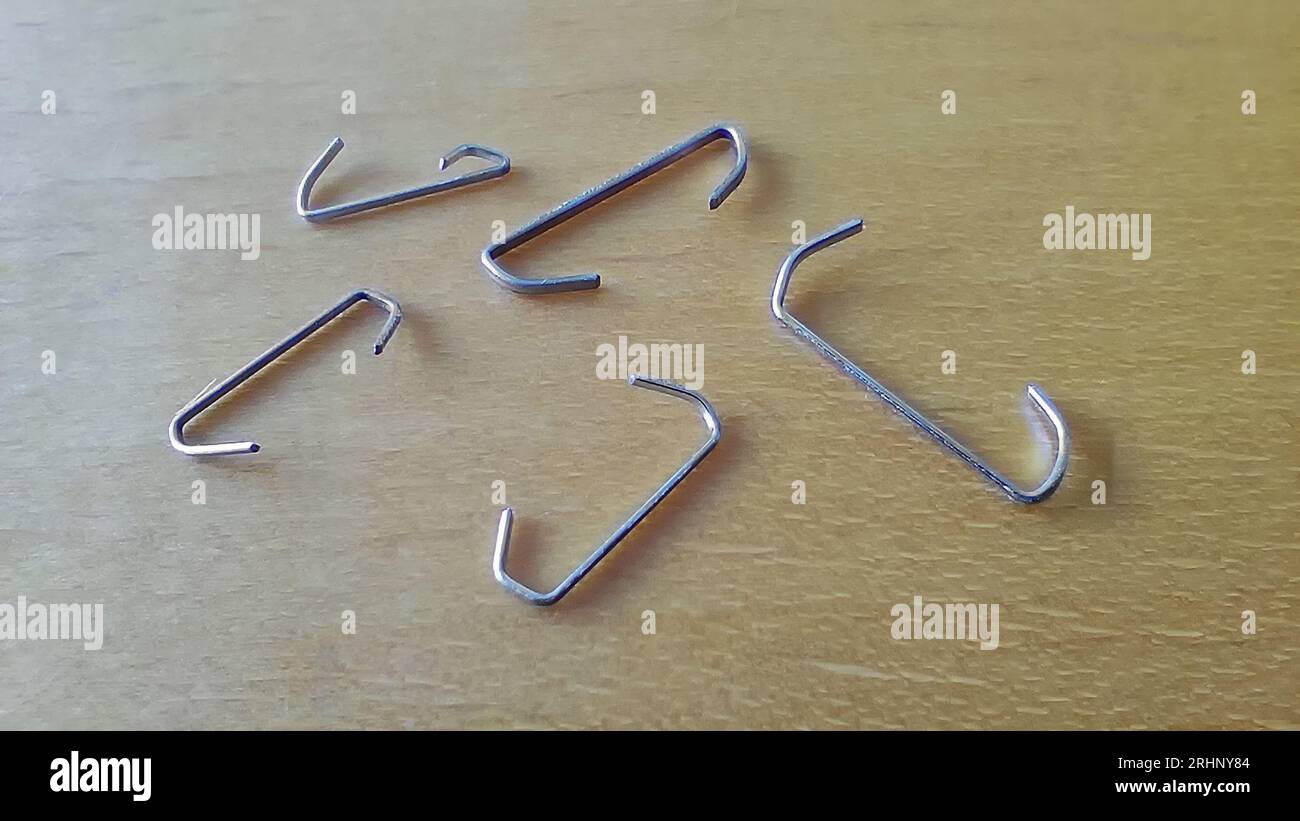 Silver paper clips on table background in office Stock Photo - Alamy
