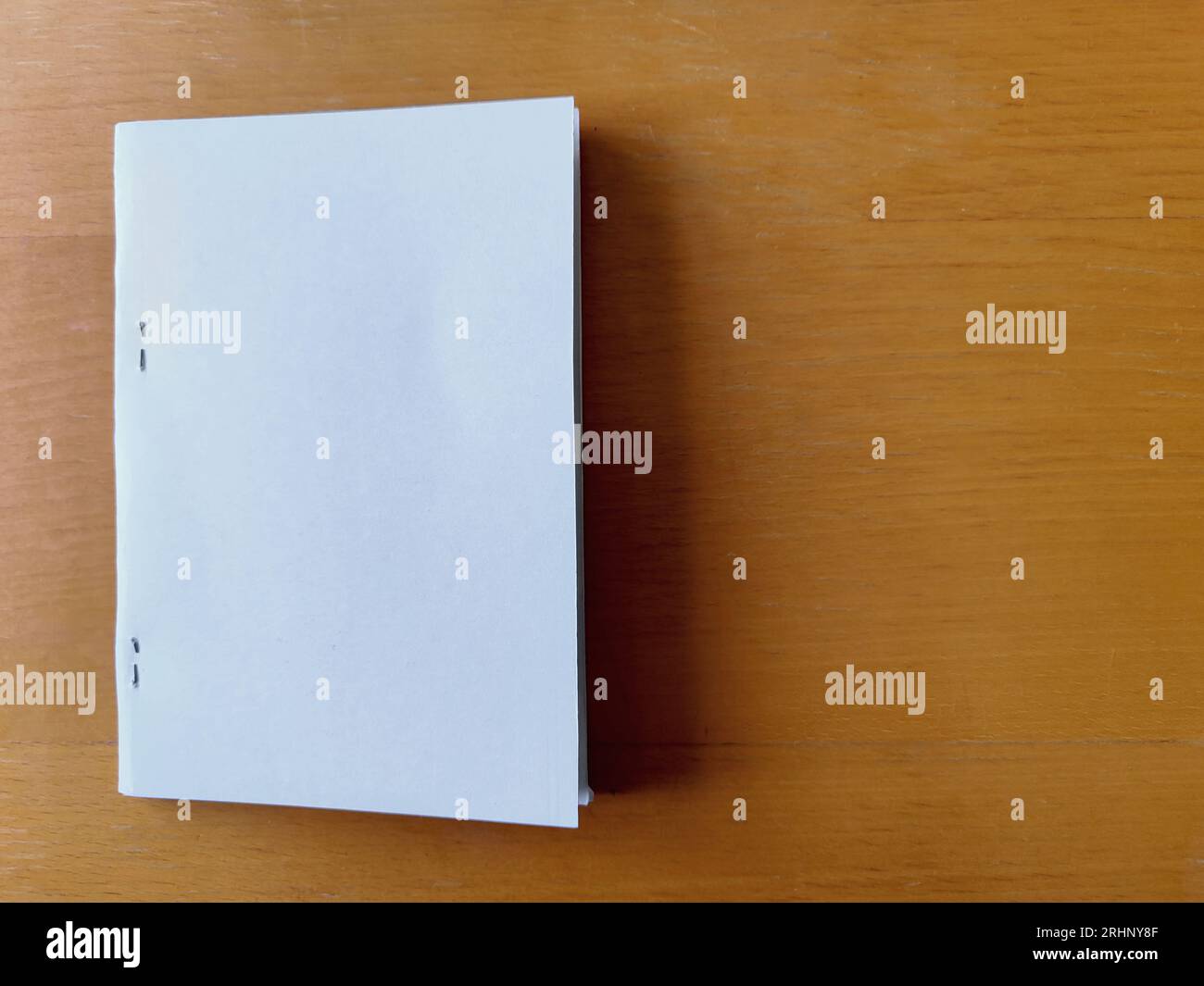 Paper documents are stacked on a wooden table at the workplace.Business ...