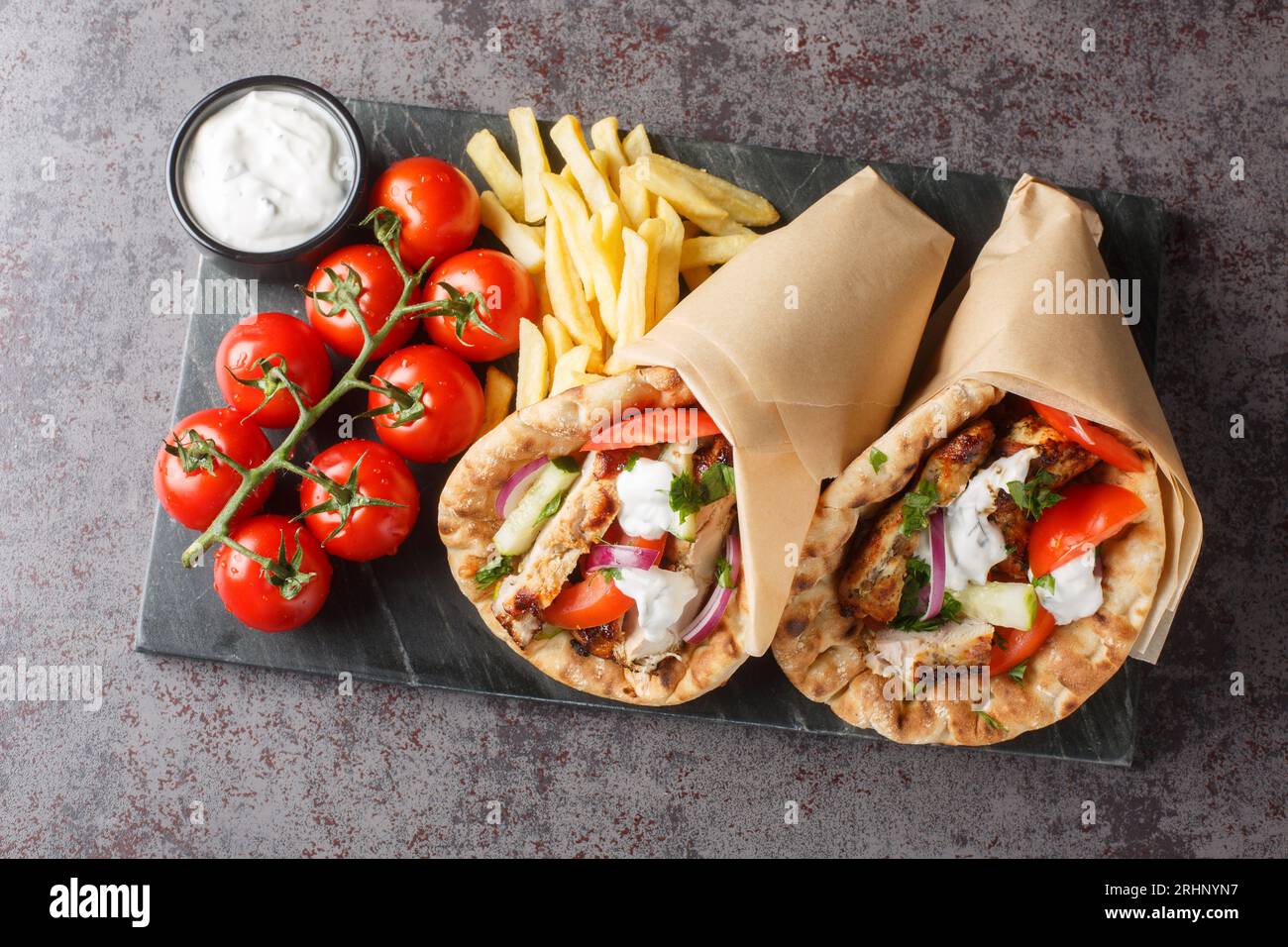 Chicken gyros with vegetables, french fries and tzatziki sauce closeup ...