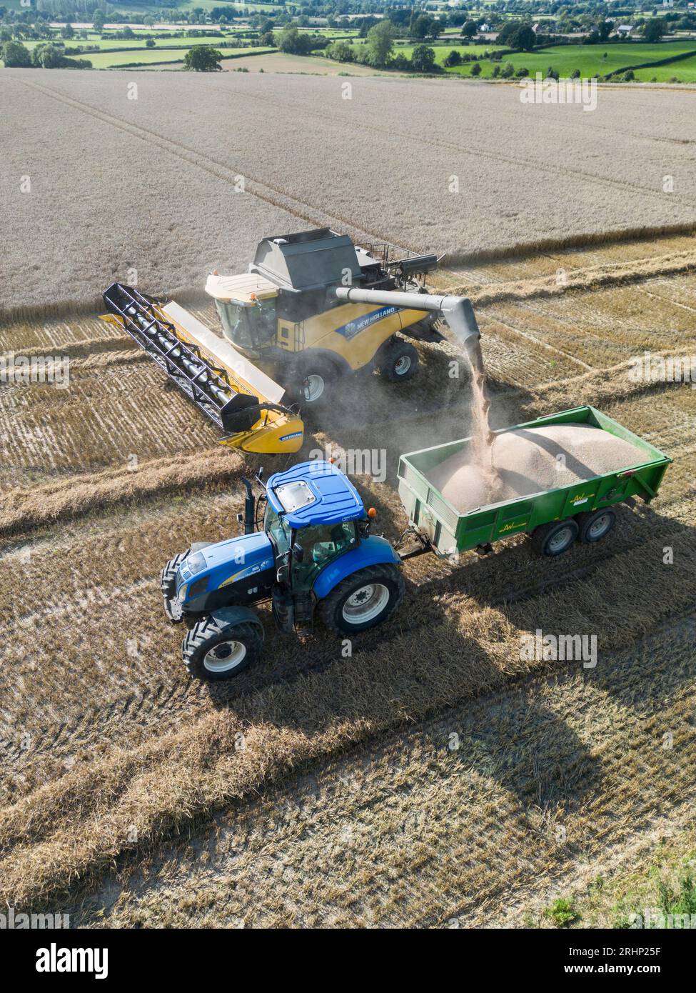 Aerial photographs of a combine harvester and tractors harvesting ...