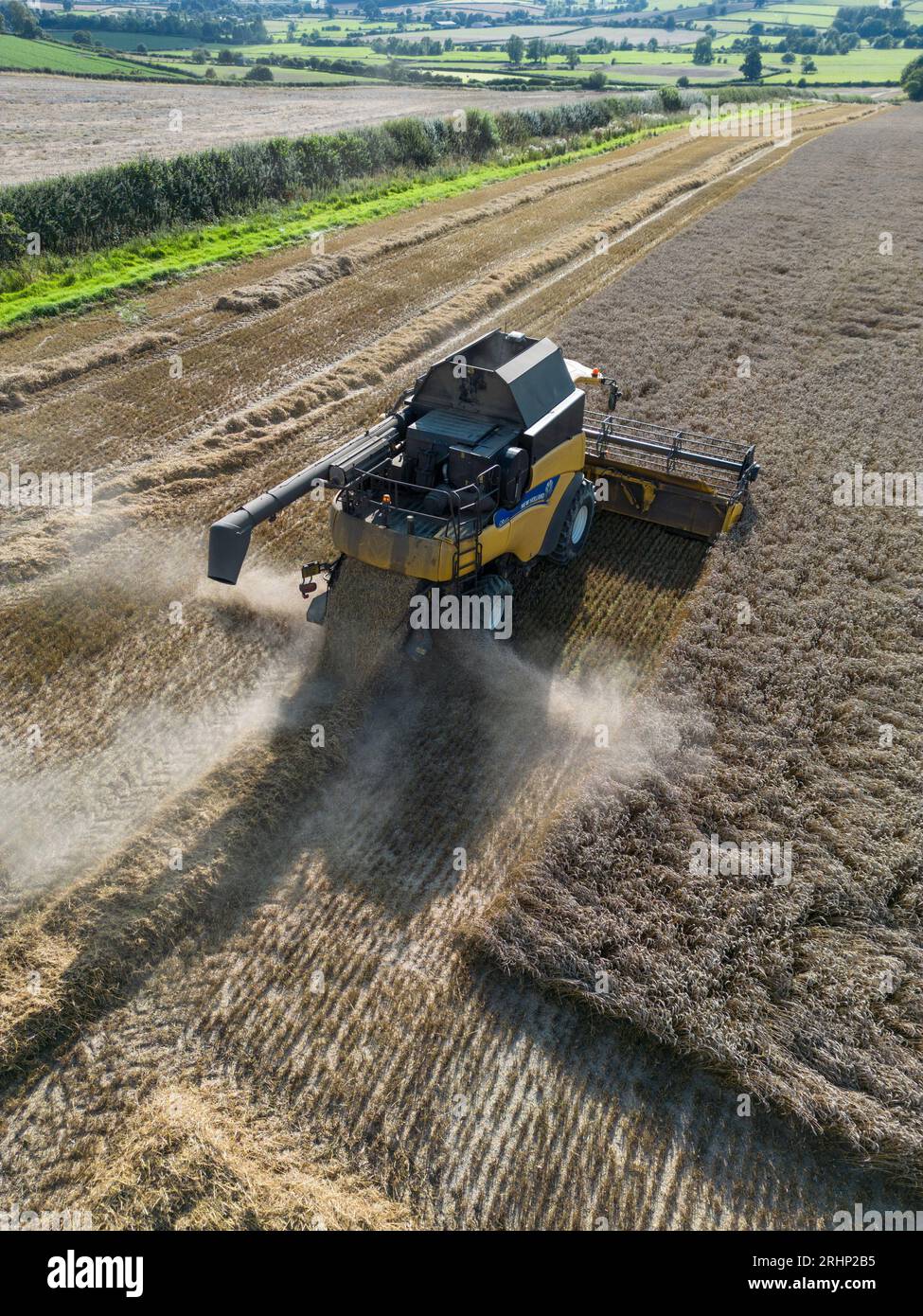 Aerial photographs of a combine harvester and tractors harvesting ...